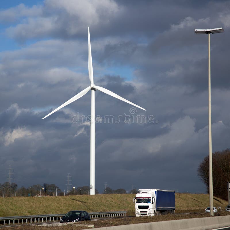 Windmill next to highway stock photo. Image of driving - 50720926