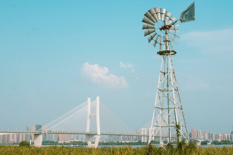 Windmill for Pumping Water from Wind Power on Grass Fields Under Blue ...