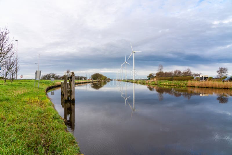Windmill at the river stock image. Image of holland - 322447611
