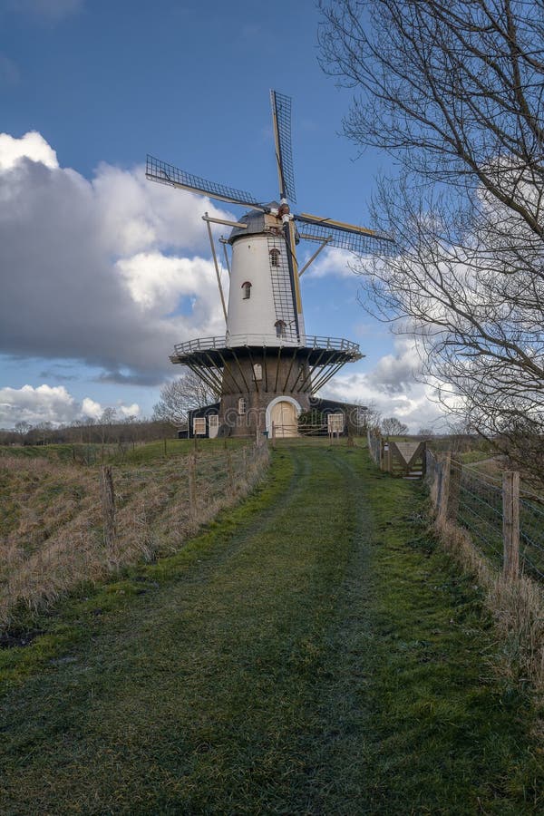 Windmill in rural road. stock image. Image of rural, travel - 55613999