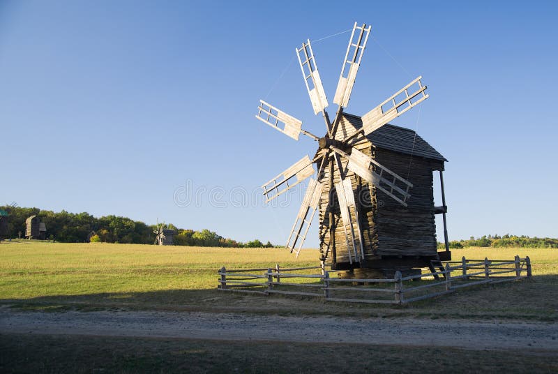 Windmill Standing in the Field Against the Blue Sky Stock Image - Image ...