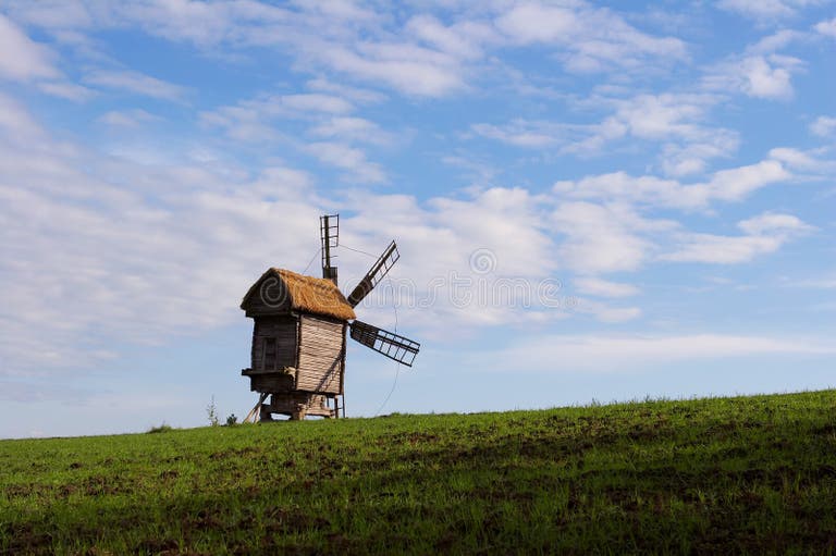 Windmill with a straw roof stock photo. Image of field - 1779400