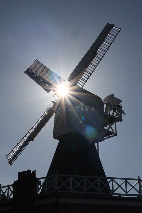 A Windmill with the Sun Shining through the Middle Stock Image - Image ...