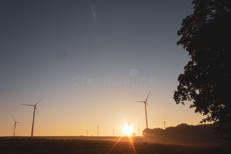 Windmill at sunrise stock photo. Image of turbine, wind - 137321368