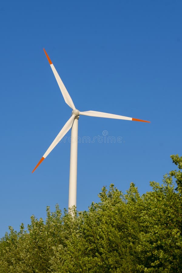 Windmill in Tree Branches on Blue Sky Background.renewable Energy Stock ...