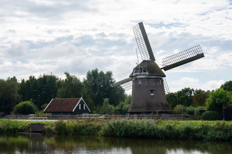 A Windmill on the Water in the Netherlands Stock Photo - Image of ...