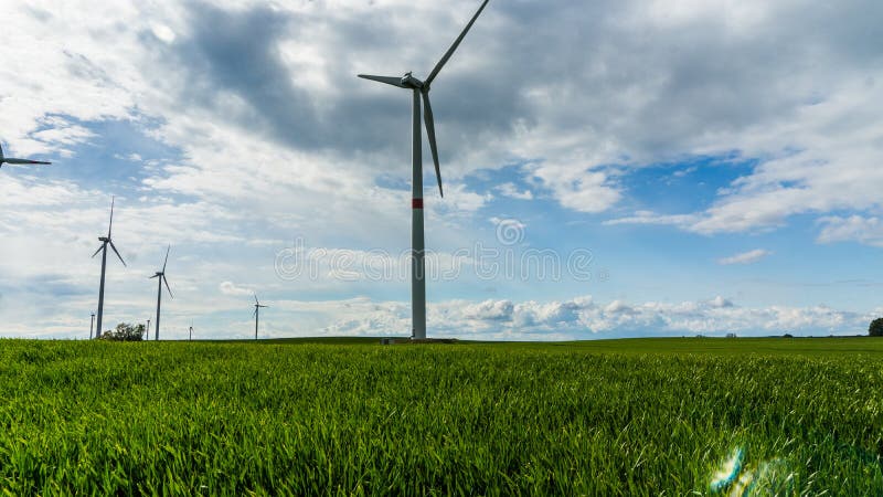 Windmills on a field stock image. Image of ecology, cloudy - 139850039