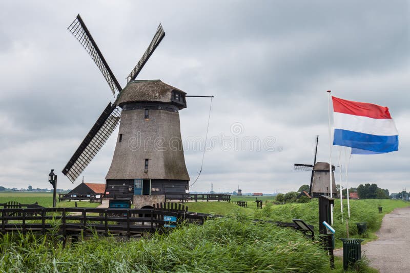 Windmills in Marsh Landscape with Dutch Flags Stock Image - Image of ...