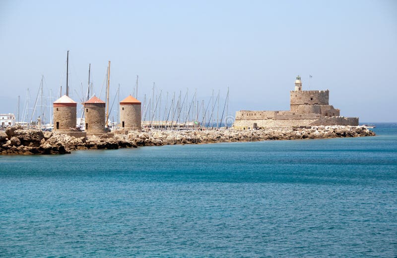 Windmills at Rhodes harbor stock photo. Image of history - 20137356