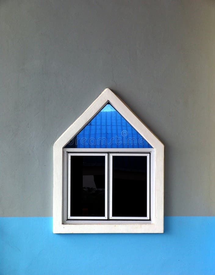 Geometric Window Design with Blue Tiles and Two-Tone Wall Stock Photo ...