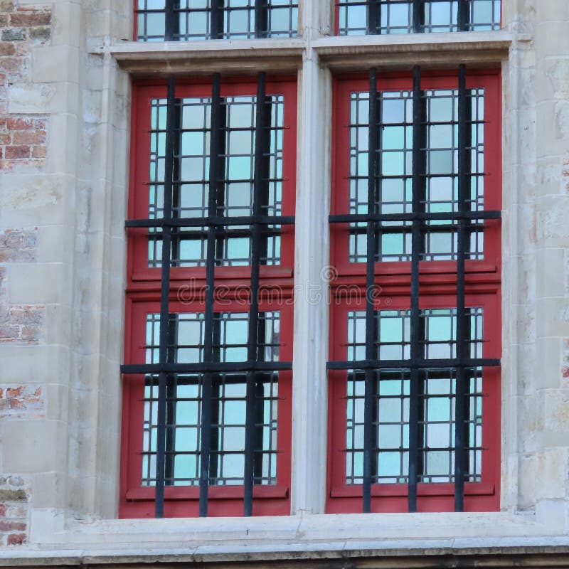 A Window with Black Railings and Red Frames Stock Photo - Image of ...
