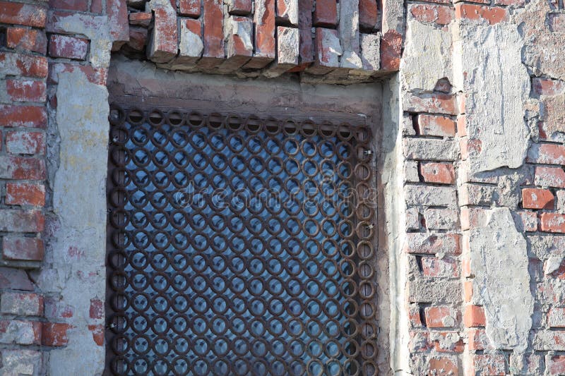 A Window in a Brick Building with a Metal Grate, Suitable for Use in ...