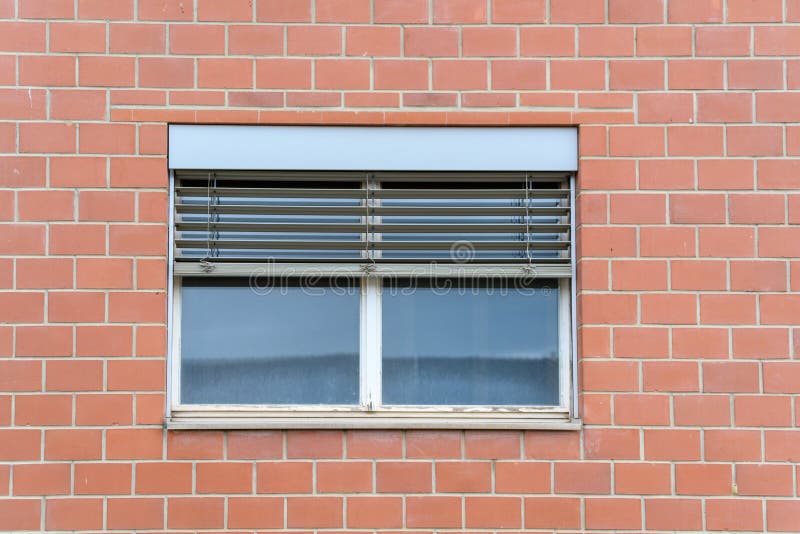 A Window on a Brick Wall with Half-lowered Shutters. Stock Image ...