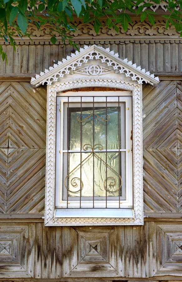 Window with carved patterns on old wooden house
