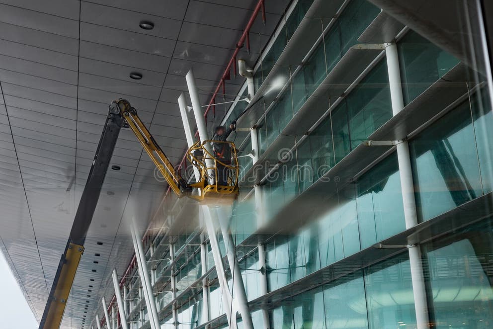 Window Cleaner at Airport Hall, Standing on a Crane Stock Image - Image ...