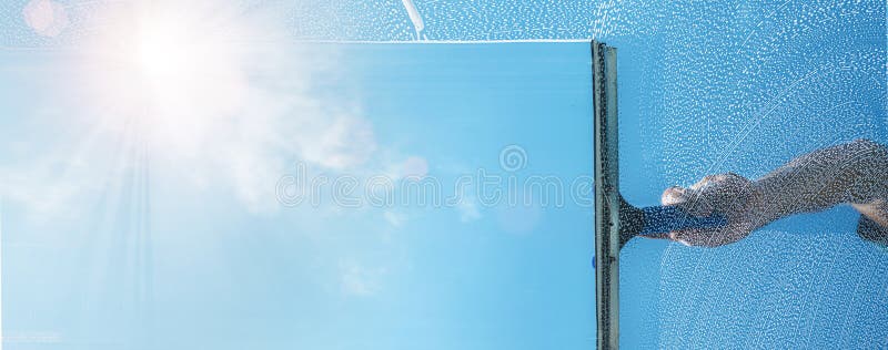 Window Cleaner Cleaning Window with Squeegee and Wiper on a Sunny Day ...