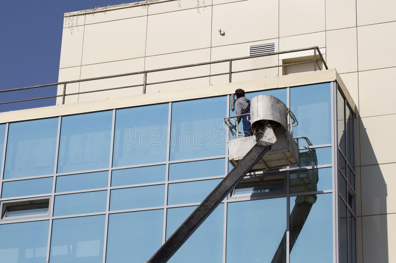 Window Cleaner on a High-rise Building. Window Washing with the Help of ...