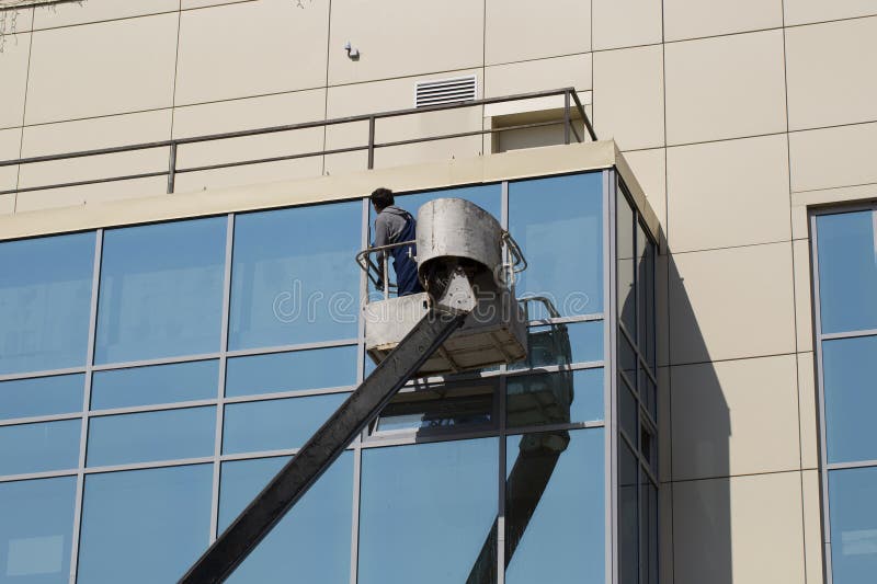 Window Cleaner on a High-rise Building. Window Washing with the Help of ...