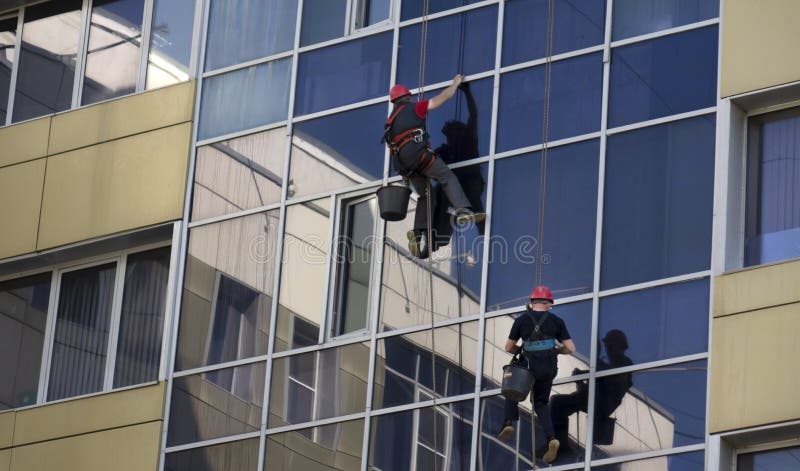 Window Cleaners. Qualified High-rise Workers Wash the Glass Windows of ...