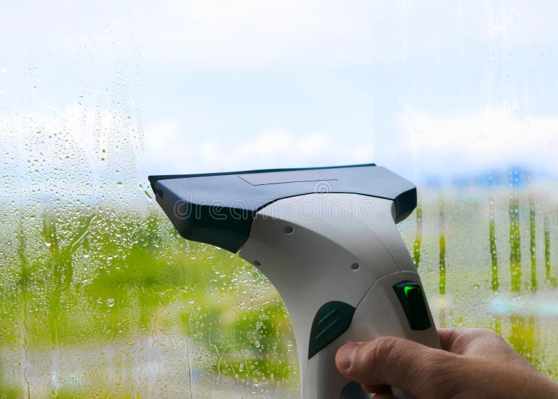 Window Cleaning with Glass Cleaner. Man& X27;s Hand Holding a ...