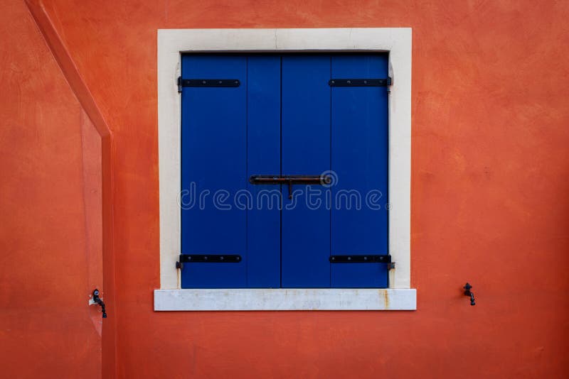 Window with Closed Blue Shutters on an Orange Wall Stock Photo - Image ...