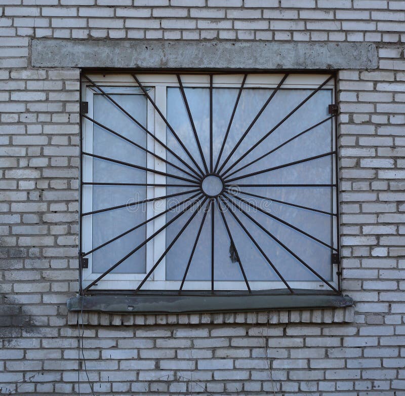 Window Covered by a Metal Grate in a White Brick Wall Stock Image ...