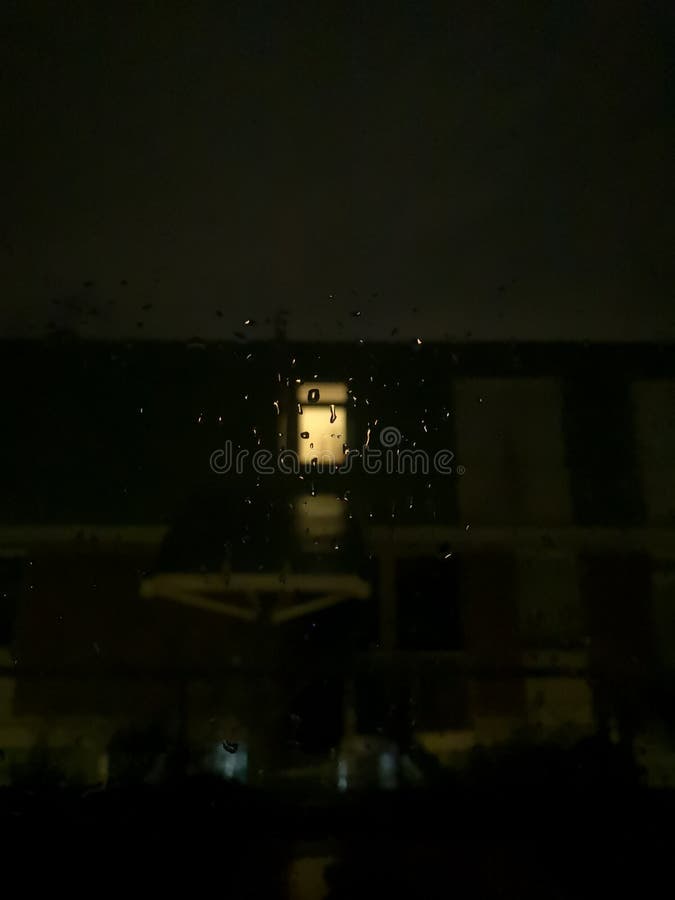 Window in the Darkness with Drops of Rain Stock Image - Image of yellow ...