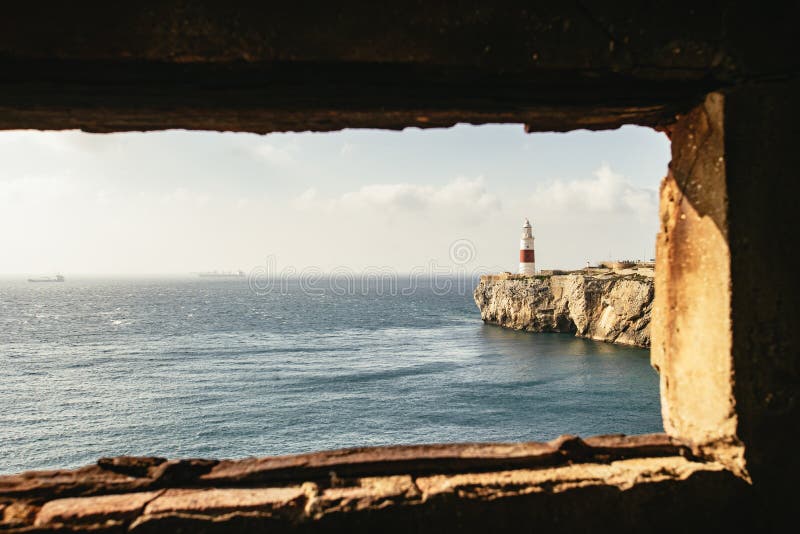 Window in Foreground Providing View of Lighthouse Stock Image - Image ...