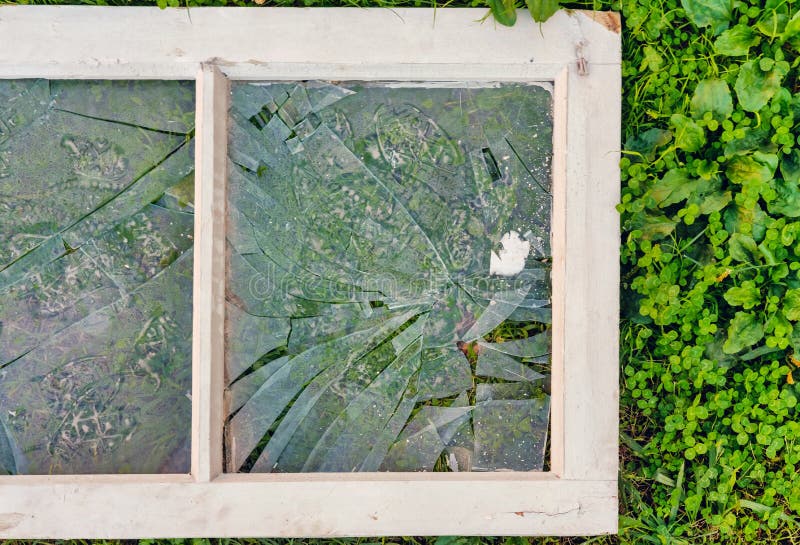 Window Frame with Cracked Glass Lying on the Grass Stock Image - Image ...