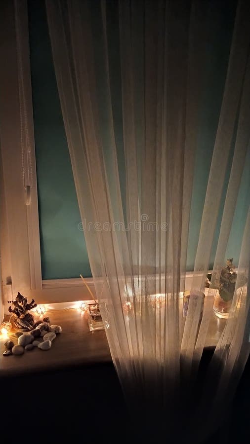 Window with a Garland of Lights and Various Decor. God Ganesha on the ...