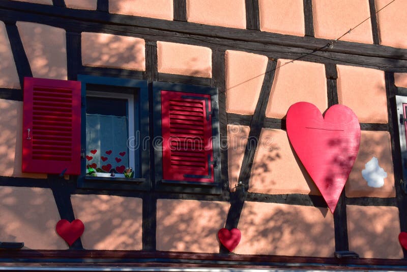 A Window on the House with Red Shutters and a Heart on the Wall. Stock ...