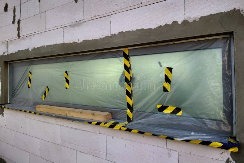 Window of a House Under Construction Covered with Protective Plastic ...