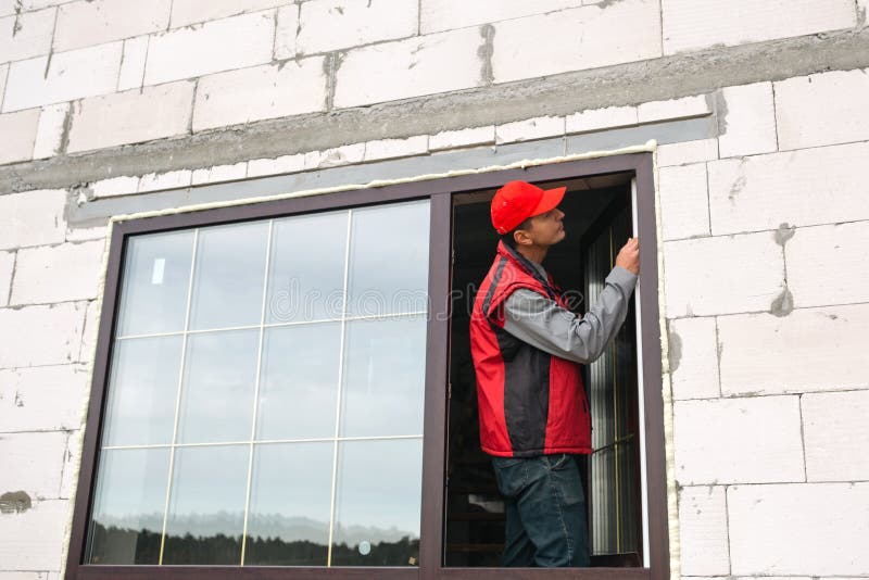 The Window Installer Adjusts the Hinges and Checks New Windows in the ...
