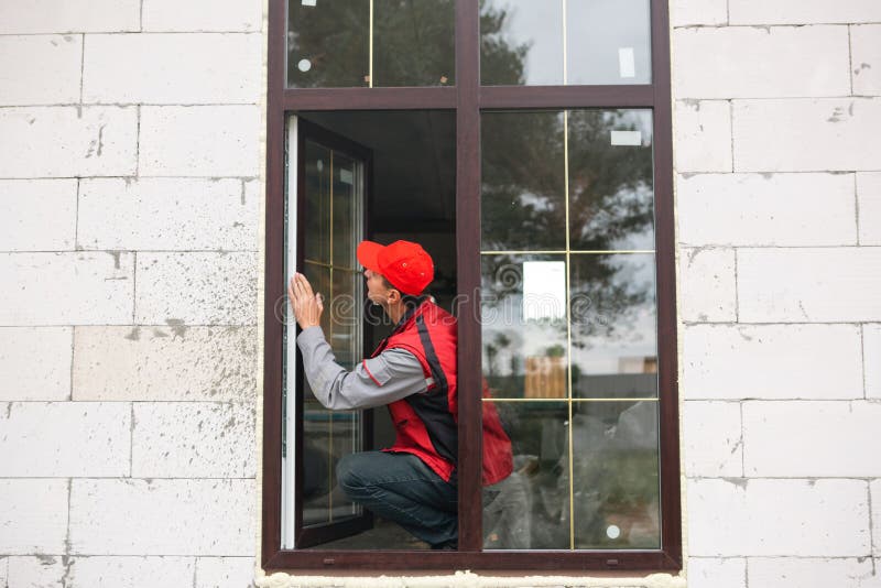 The Window Installer Adjusts the Hinges and Checks New Windows in the ...