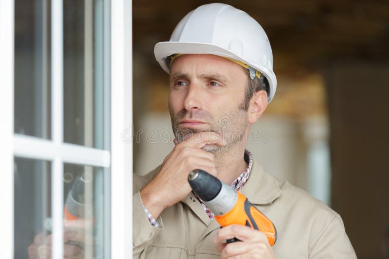 Window Installer in Contemplation Holding Drill Stock Image - Image of ...