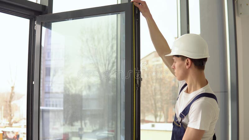 The Window Installer Measures the Dimensions of the Window Frame with a ...