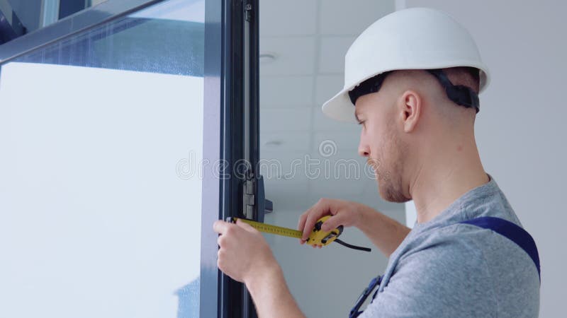 Window Installer Measures the Dimensions of the Window Frame with a ...