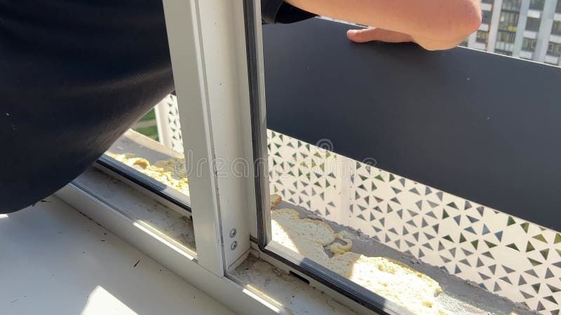 Window Insulation Process. Male Craftsman Dismantles a Window Sill for ...
