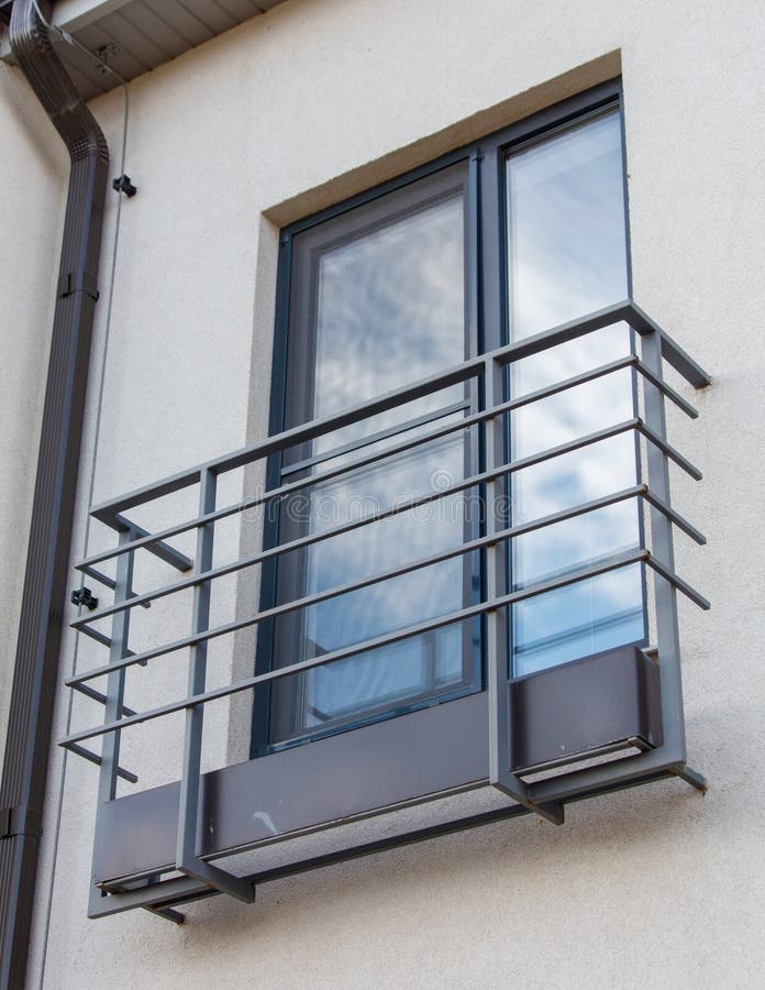 A Window with a Metal Railing and a Window Box Stock Photo - Image of ...