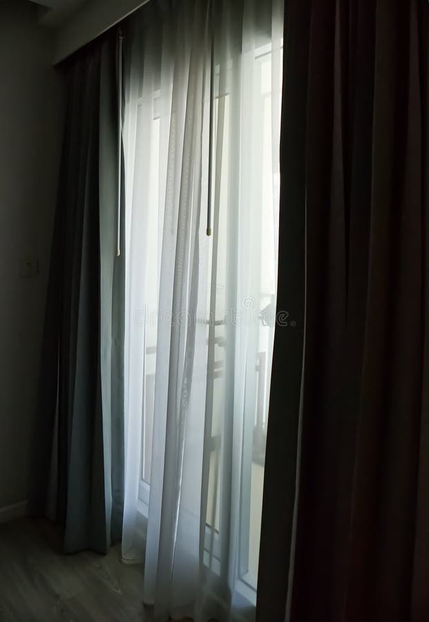 A Window with Natural Light Streaming in through the Curtains Stock ...