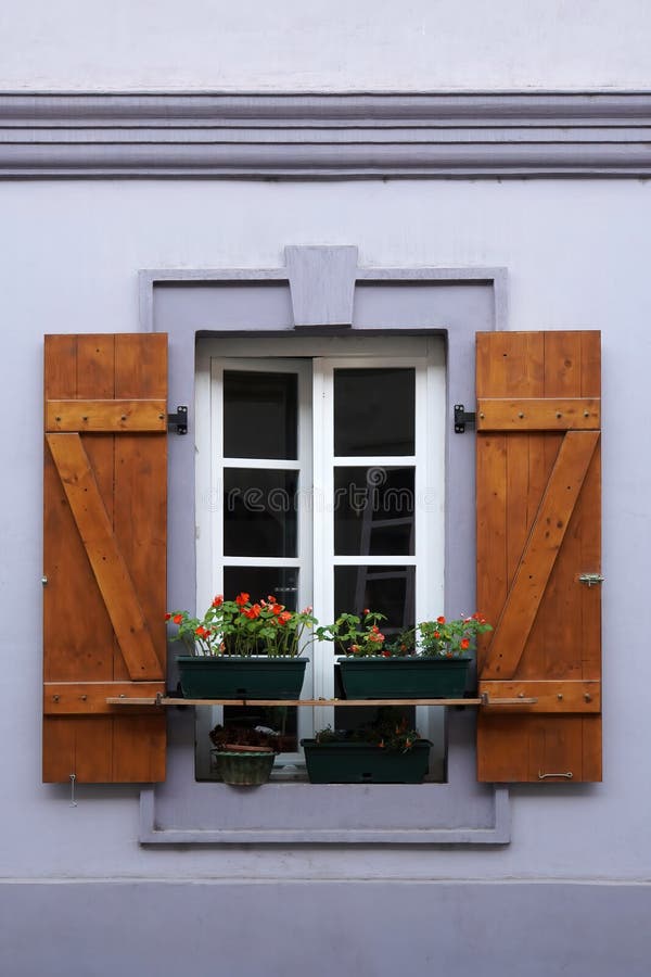 Window with Open Shutters and Flowers in Front of it Stock Photo ...