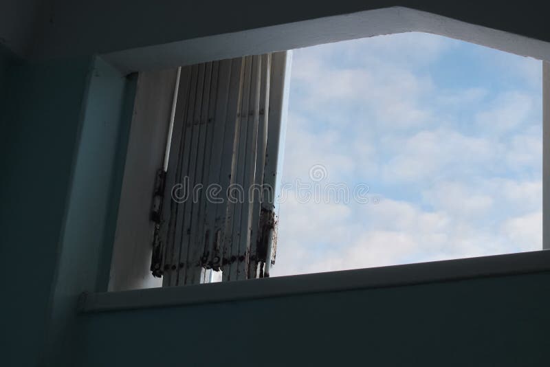 Window Overlooking the Cloudy Sky in the Dark Basement, the Old Rusty ...