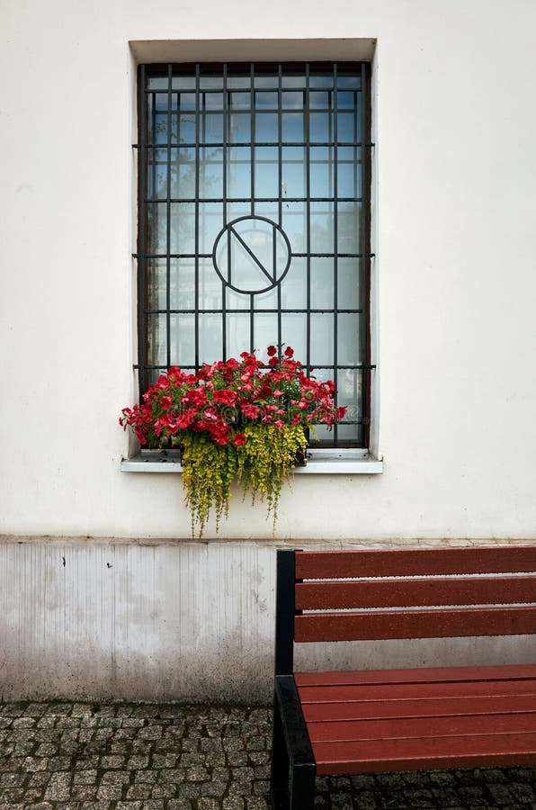 Window with a Potted Plant and a Bench Outside Stock Photo - Image of ...