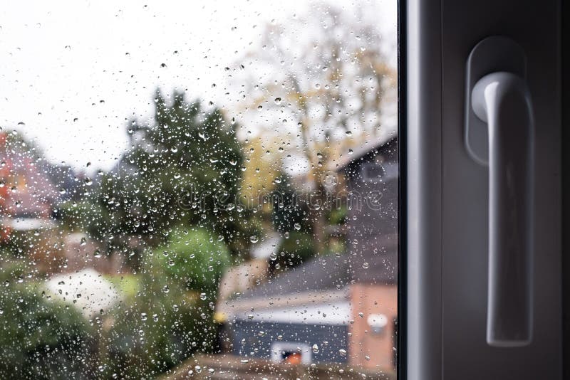 Window with Raindrops on the Glass Outside, Against the Backdrop of the ...