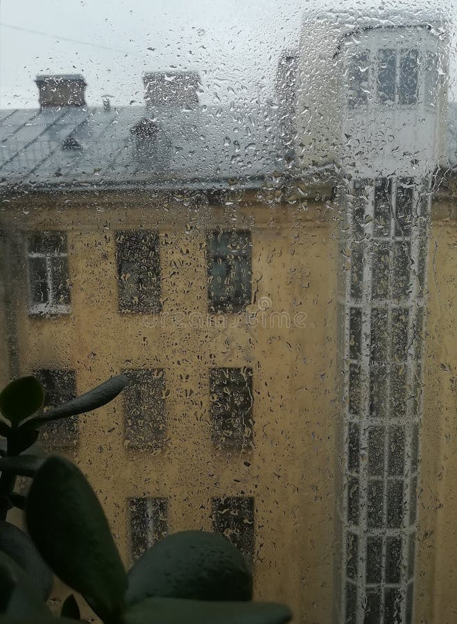 Window with Raindrops Overlooking an Old Building on a Cloudy Day Stock ...