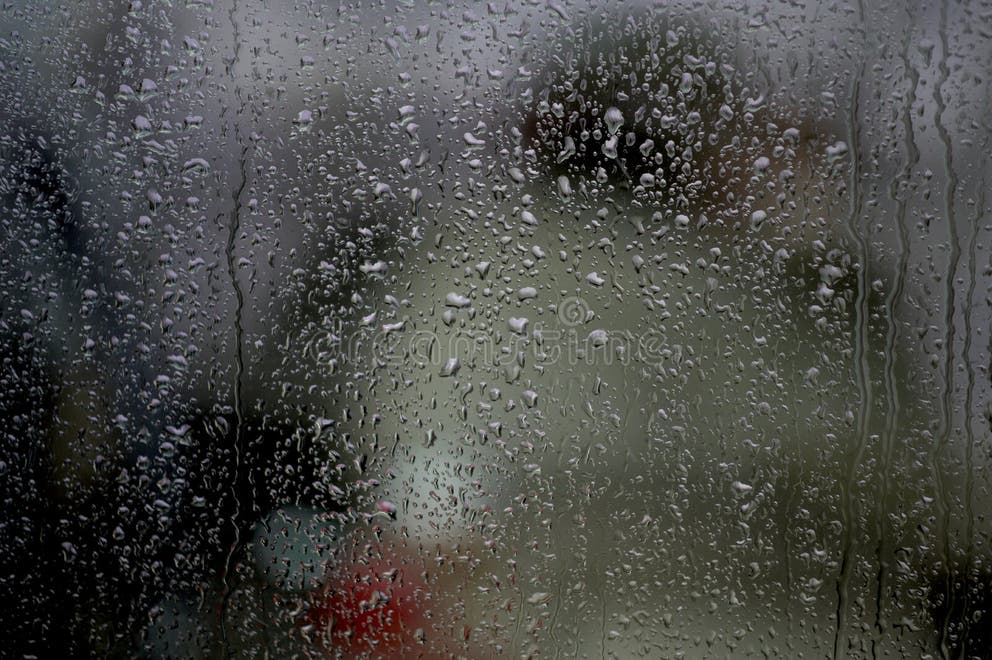 Window with Raindrops on it Under the Lights with a Blurred Background Stock Image - Image of ...