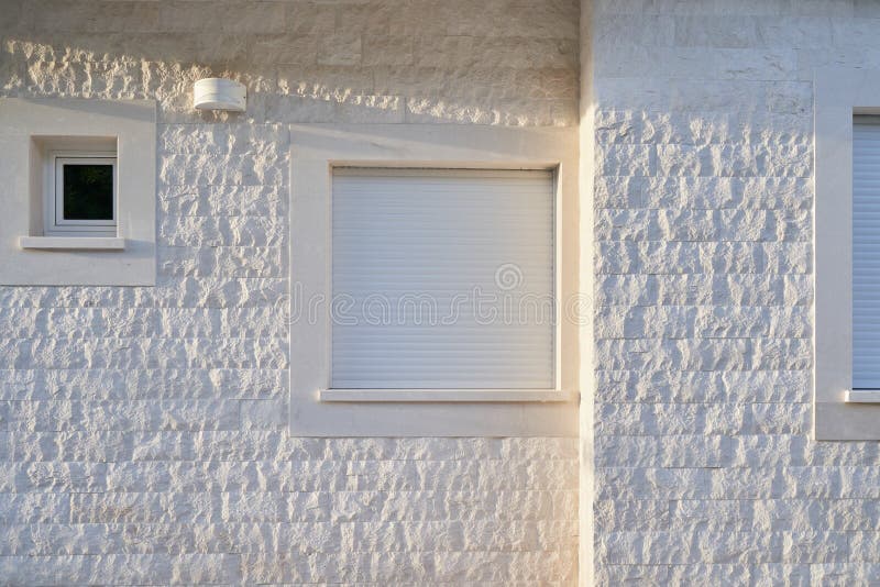 Window Roller Shutter on a Stone Finished Wall in a Modern House Stock ...