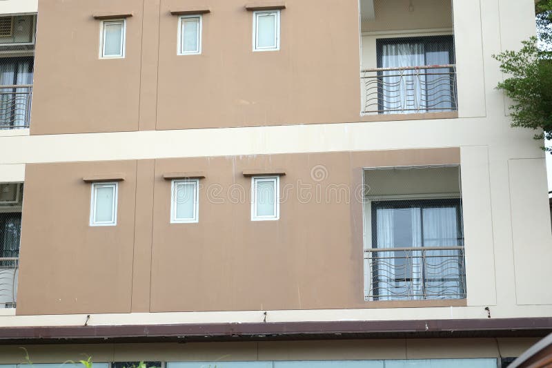 Window Row on Brown Concrete Building. Stock Image - Image of ...
