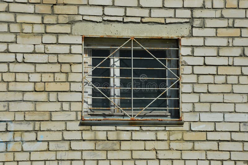 A Window with a Metal Grille, a Brick Wall. Background for the Design ...