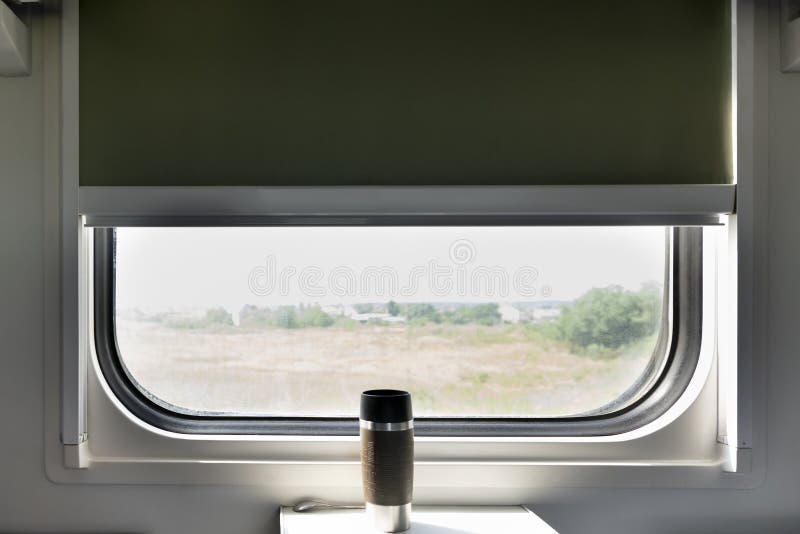 Window in Train Carriage. Thermo Mug is on Table Against the Background ...